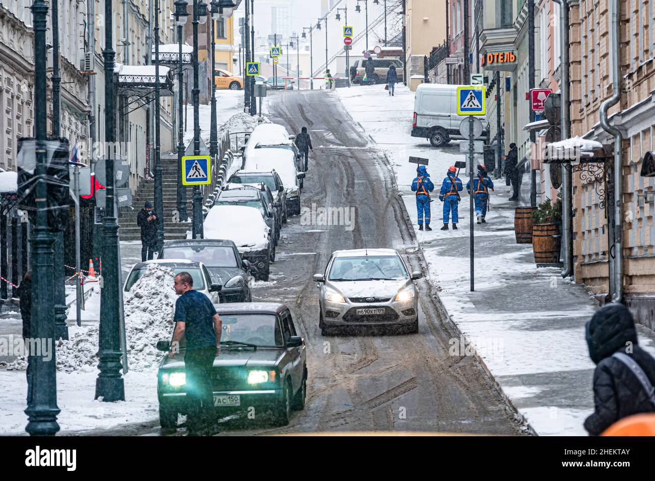 Russia, Moscow. People walk in a street during a snowfall Stock Photo ...