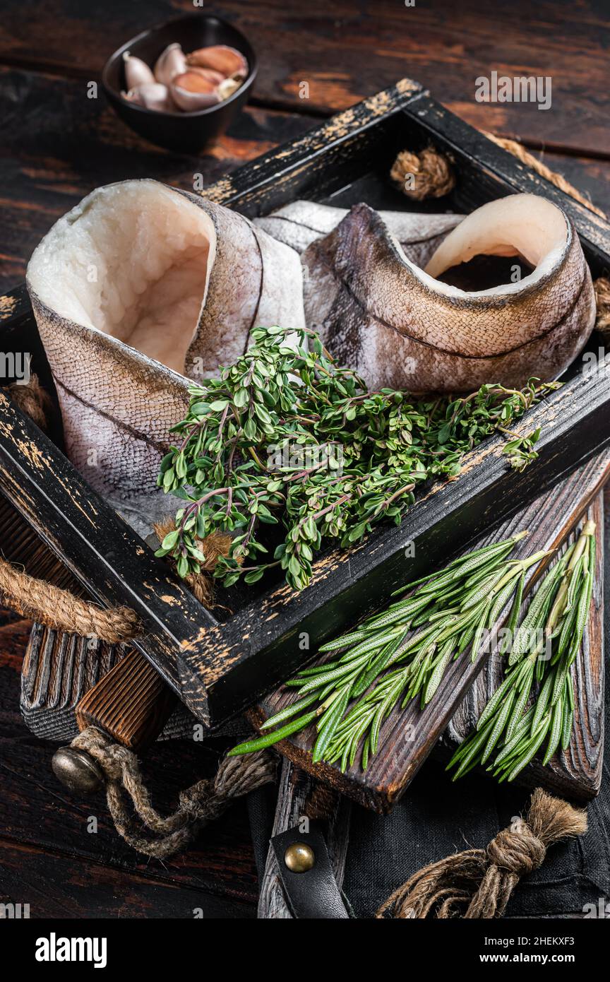 Raw Haddock fish fillets in wooden tray with rosemary and thyme. Wooden ...