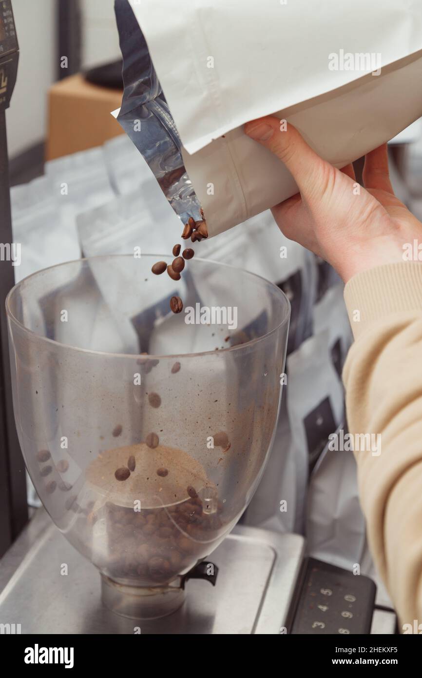 Weighing coffee grains on digital scale. Hands of female barista ...