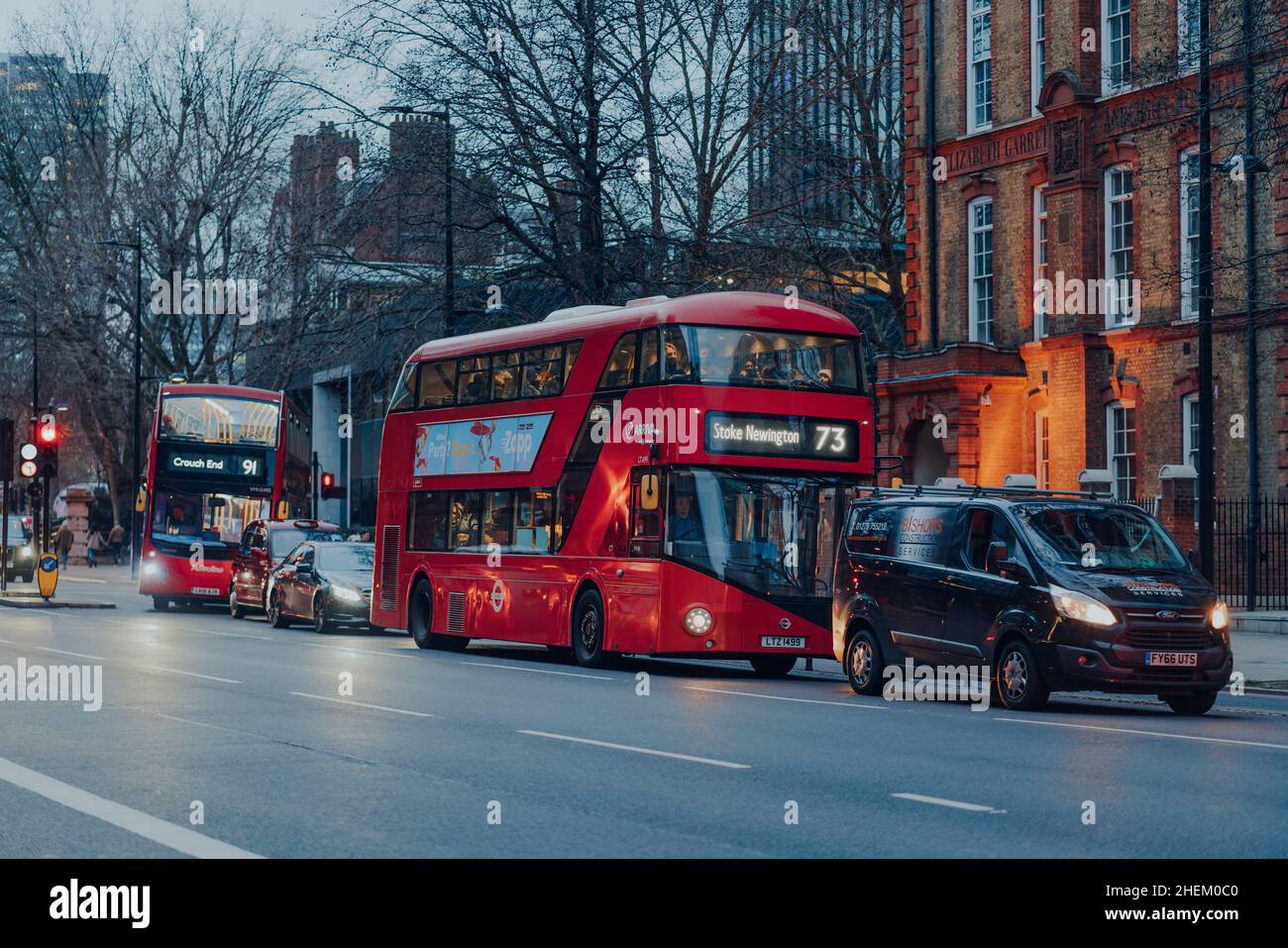 London, UK - January 01, 2022: Modern red double decker busses and ...