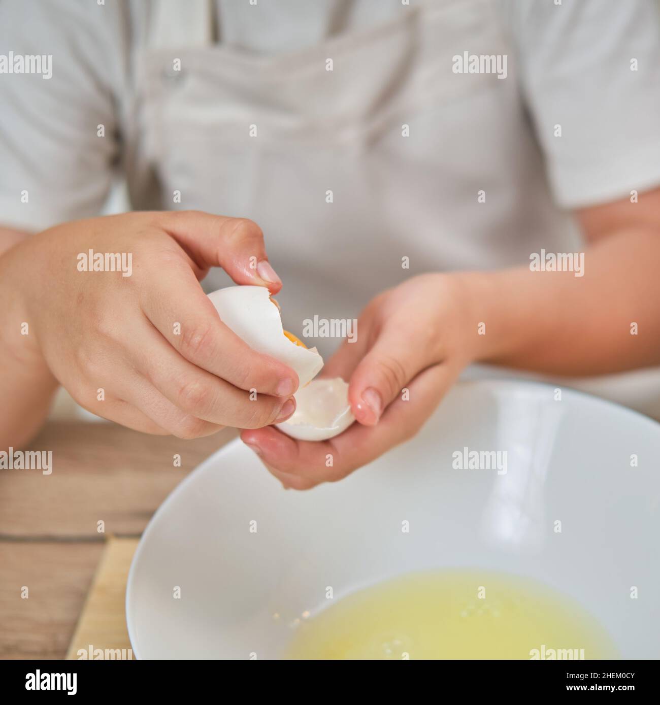 Boy hands separating the egg white from the yolk for the pie Stock Photo - Alamy