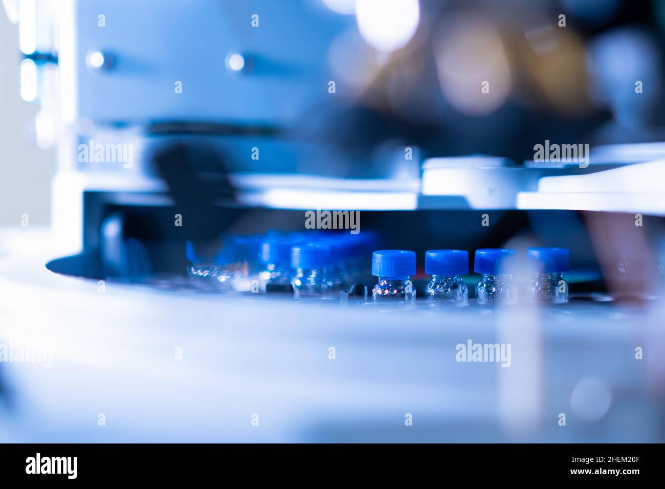 HPLC glass vials with blue caps in the auto sampler. Chemical analysis ...