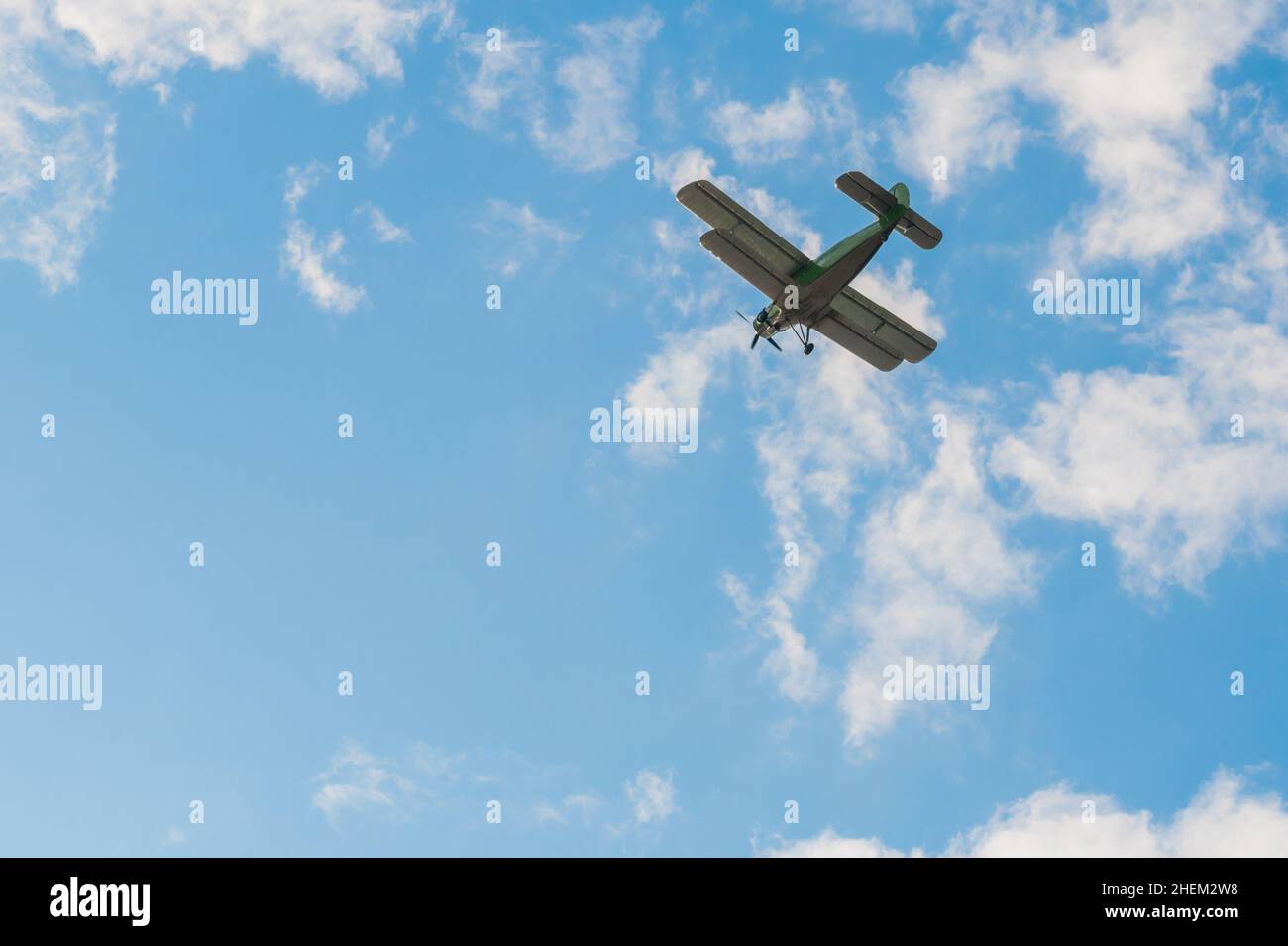 Biplane flying in blue sky and doing stunts during air show Stock Photo ...