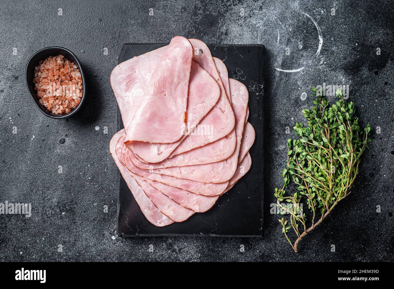 Squared slices of lean pork ham. Black background. Top view Stock Photo ...