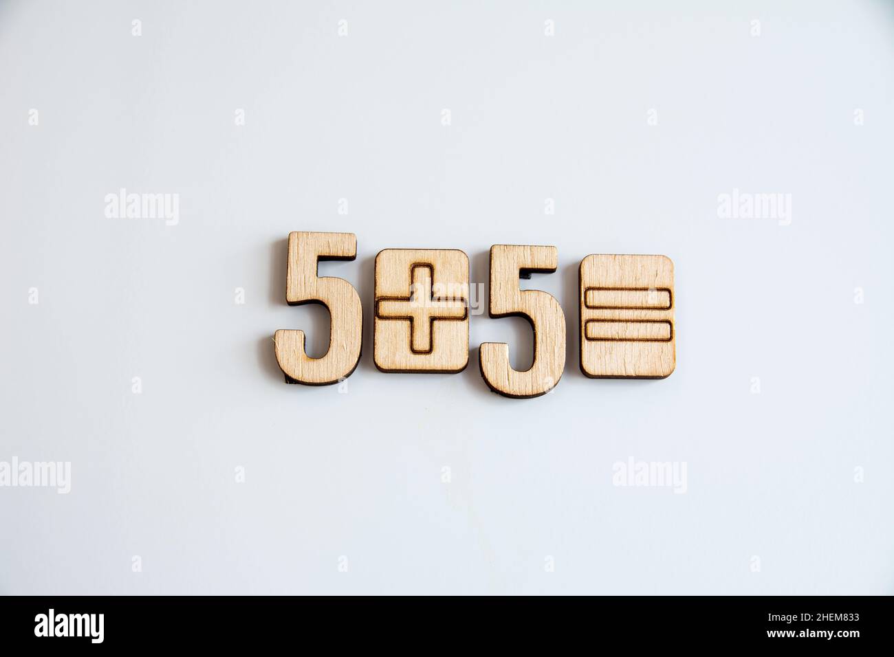Wooden numbers symbols on white background. Arithmetic, five plus five ...