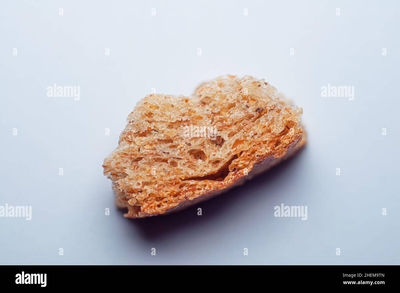 A slice of bread with a smiling face on a white background. Cracker ...