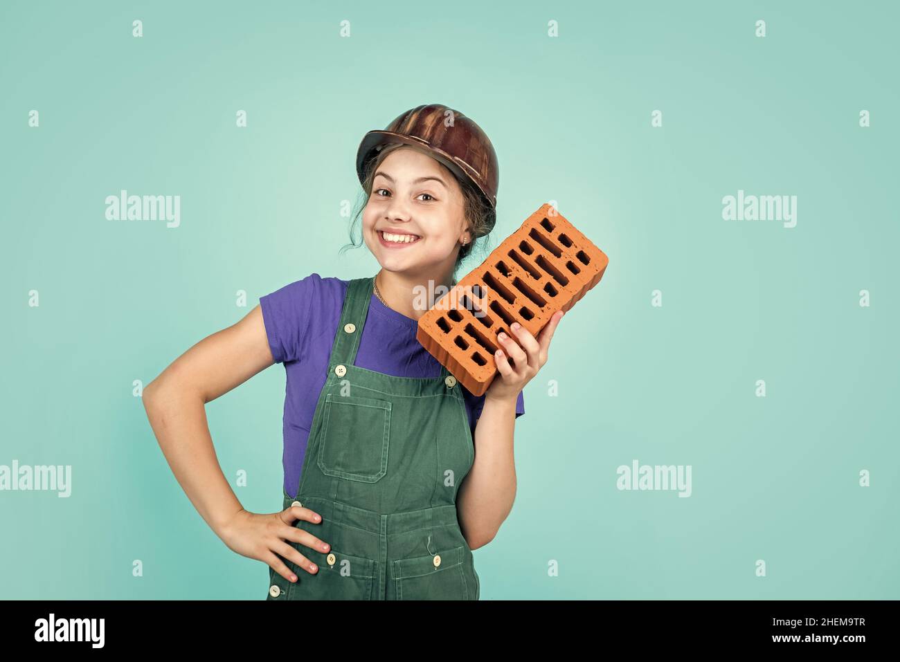 labour day. Little girl bricklayer. learning how to build. Little ...