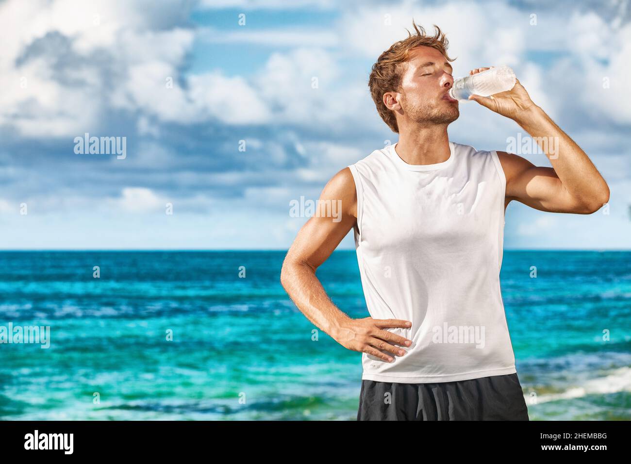 Sports drink fitness man drinking water botlle during outdoor exercise ...