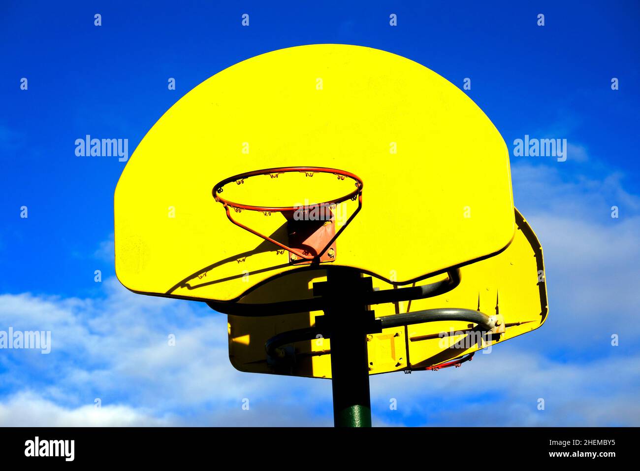 Basketball hoop with yellow backboard for competition sports blue sky ...