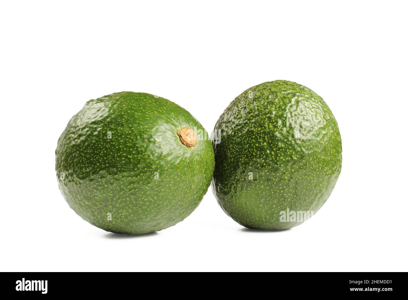 Two whole avocado fruits isolated on white background Stock Photo - Alamy