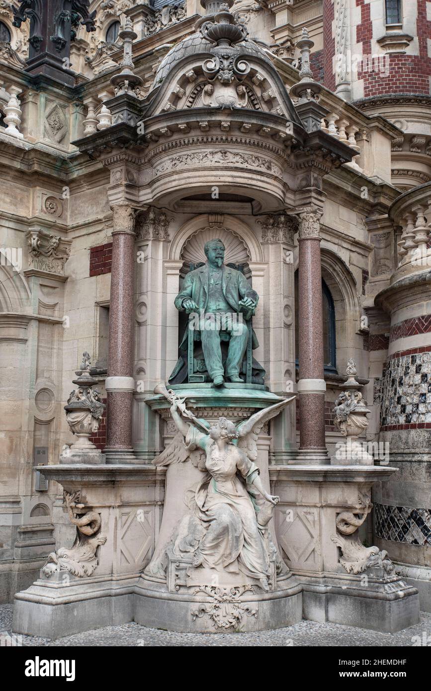 Detail of the exterior architecture of a gothic monastery with a statue ...