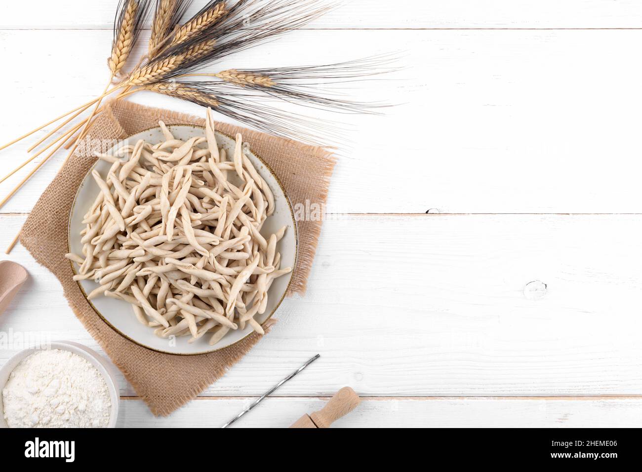 Whole grain wheat raw apulian pasta called Pizzarieddi or maccaruni on ...