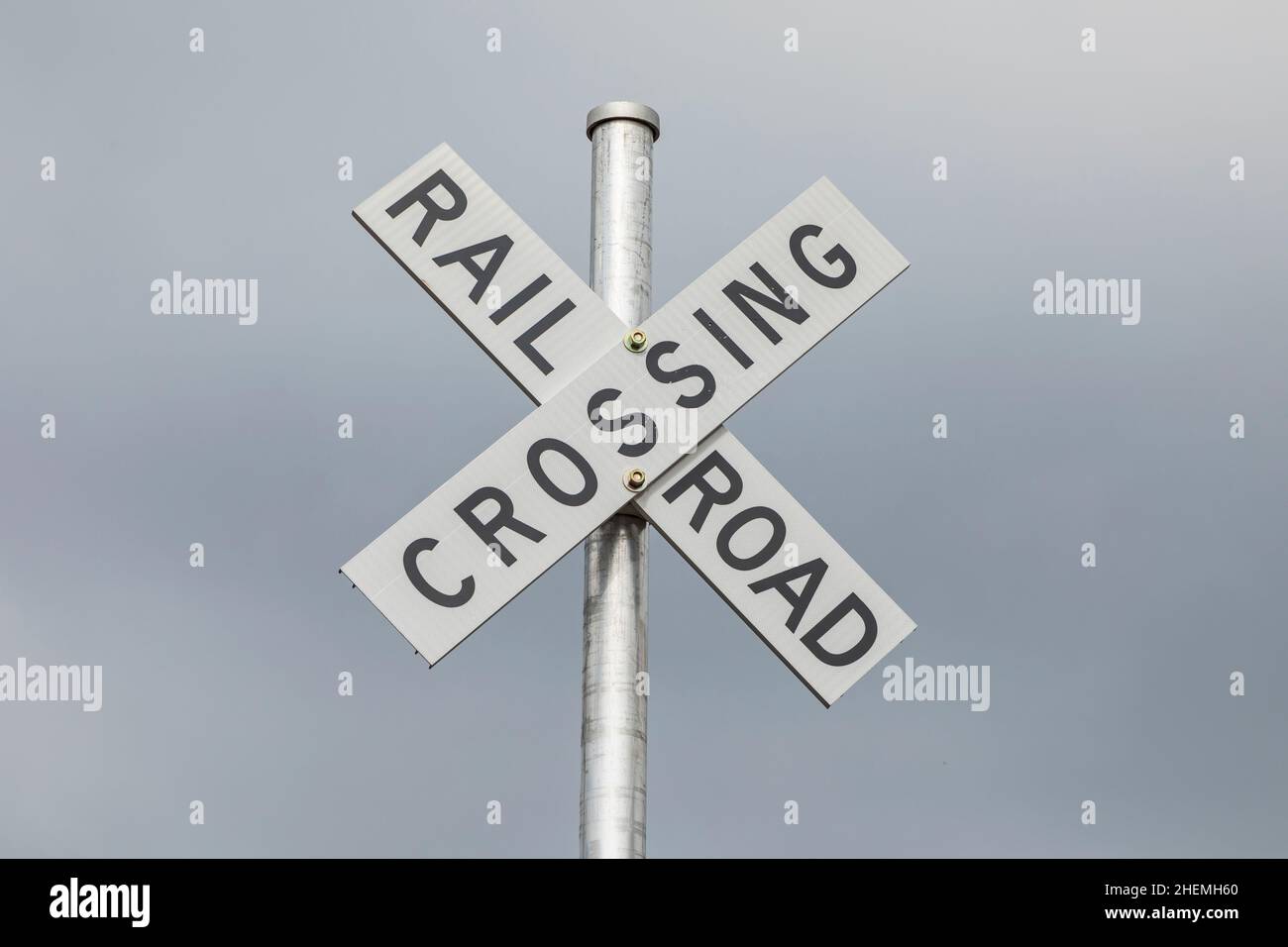railroad crossing sign in america under cloudy sky Stock Photo - Alamy