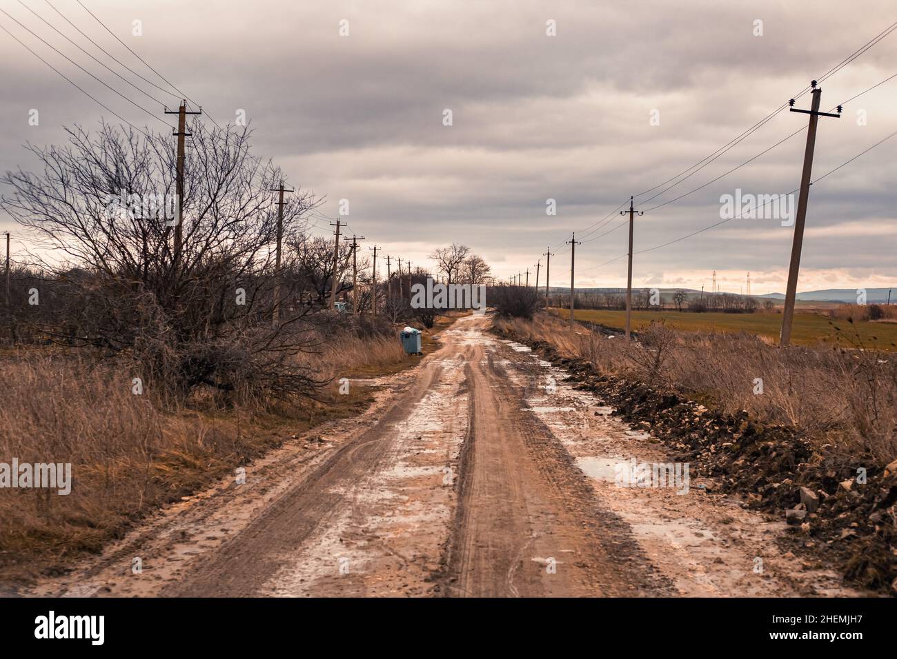 Russian rural dirt road in late autumn on a cloudy day after rains ...