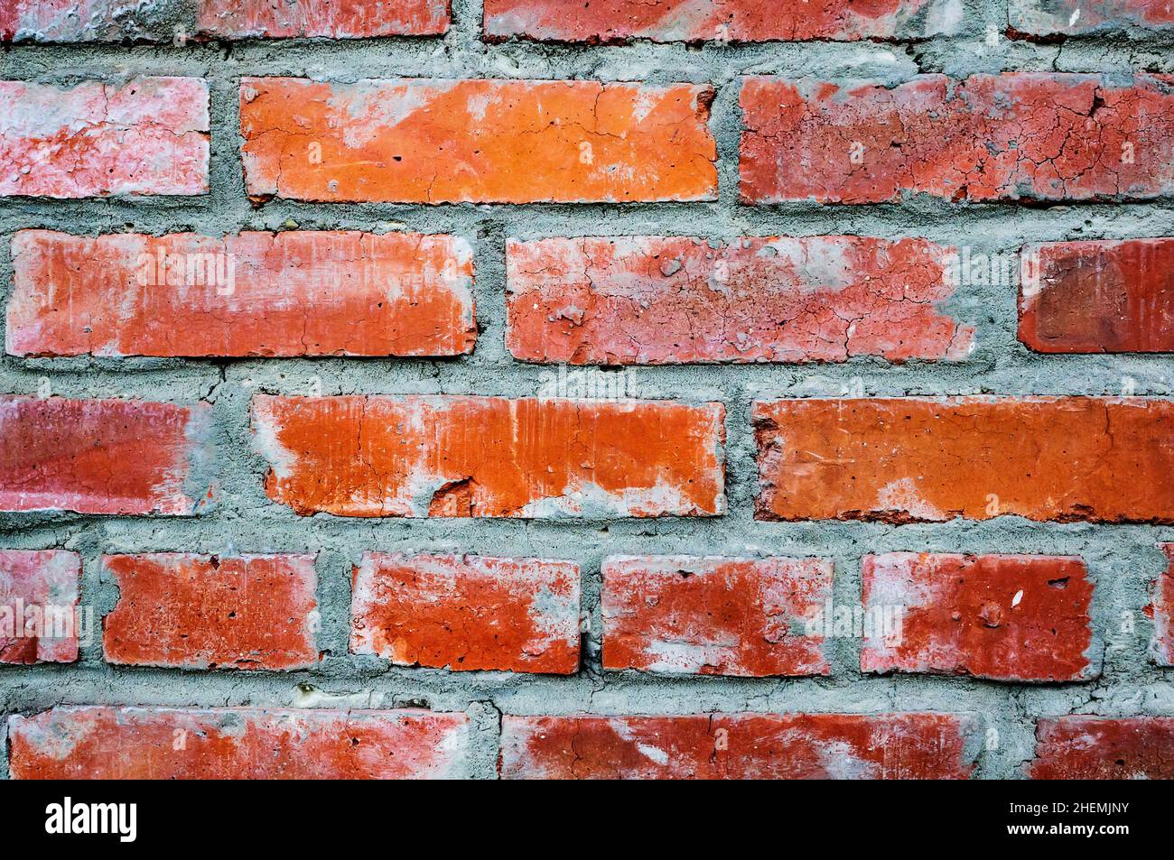 An old authentic brick wall with antique brickwork. Uneven defective ...
