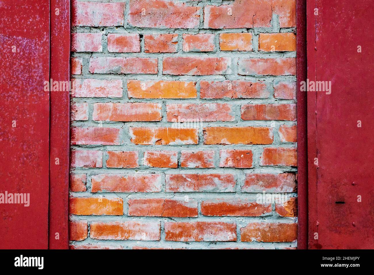 An old authentic brick wall with antique brickwork between metal red ...