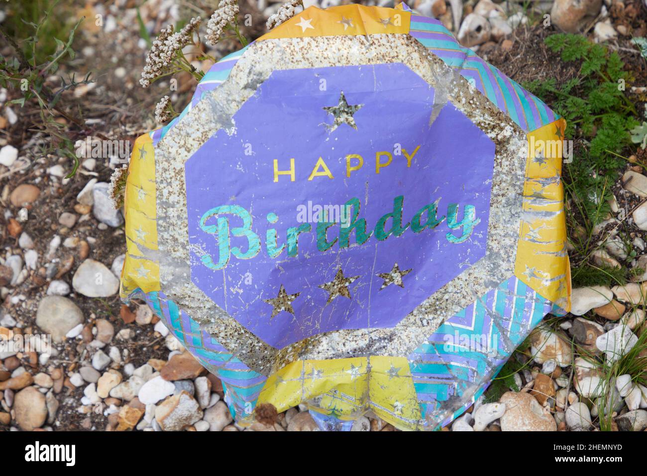 Close up of deflated birthday ballons on gravel Stock Photo - Alamy