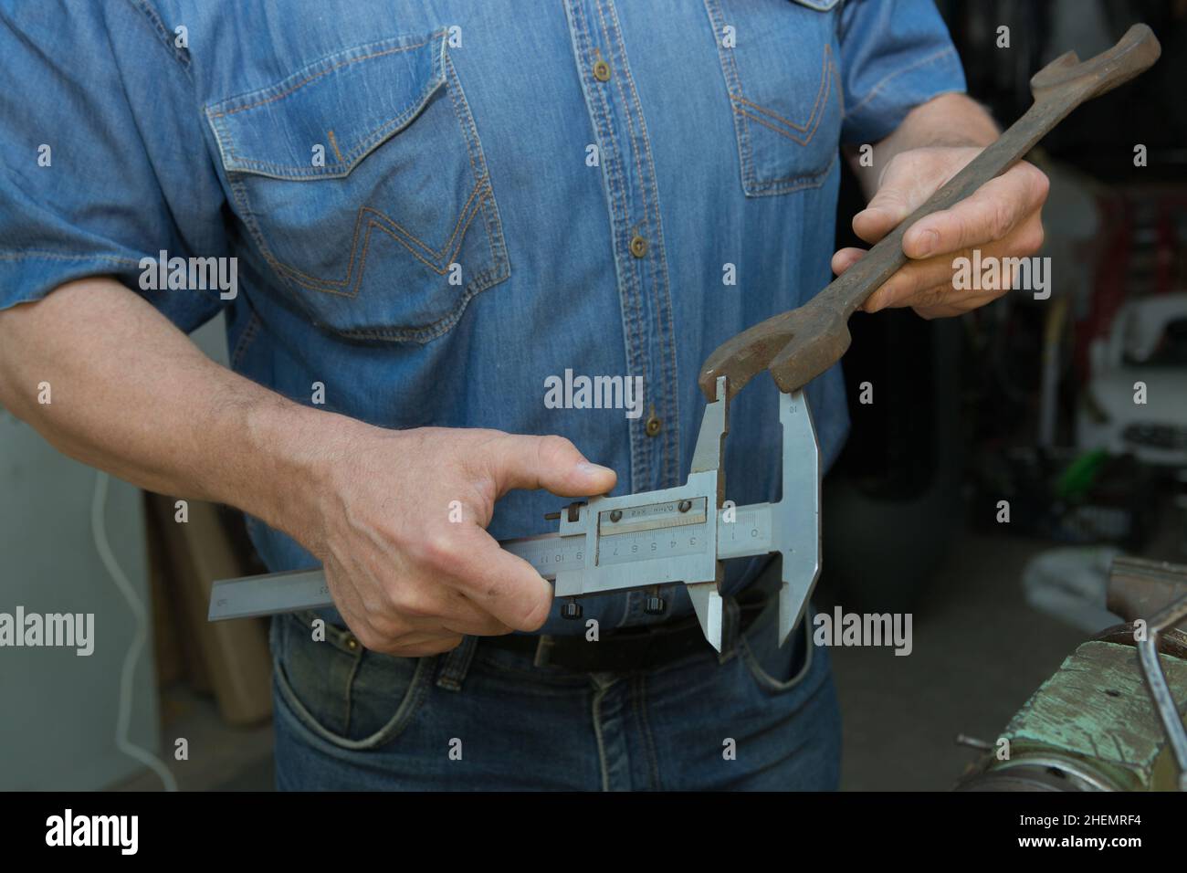 Working with a caliper. Master's hands at work. Home workshop Stock ...