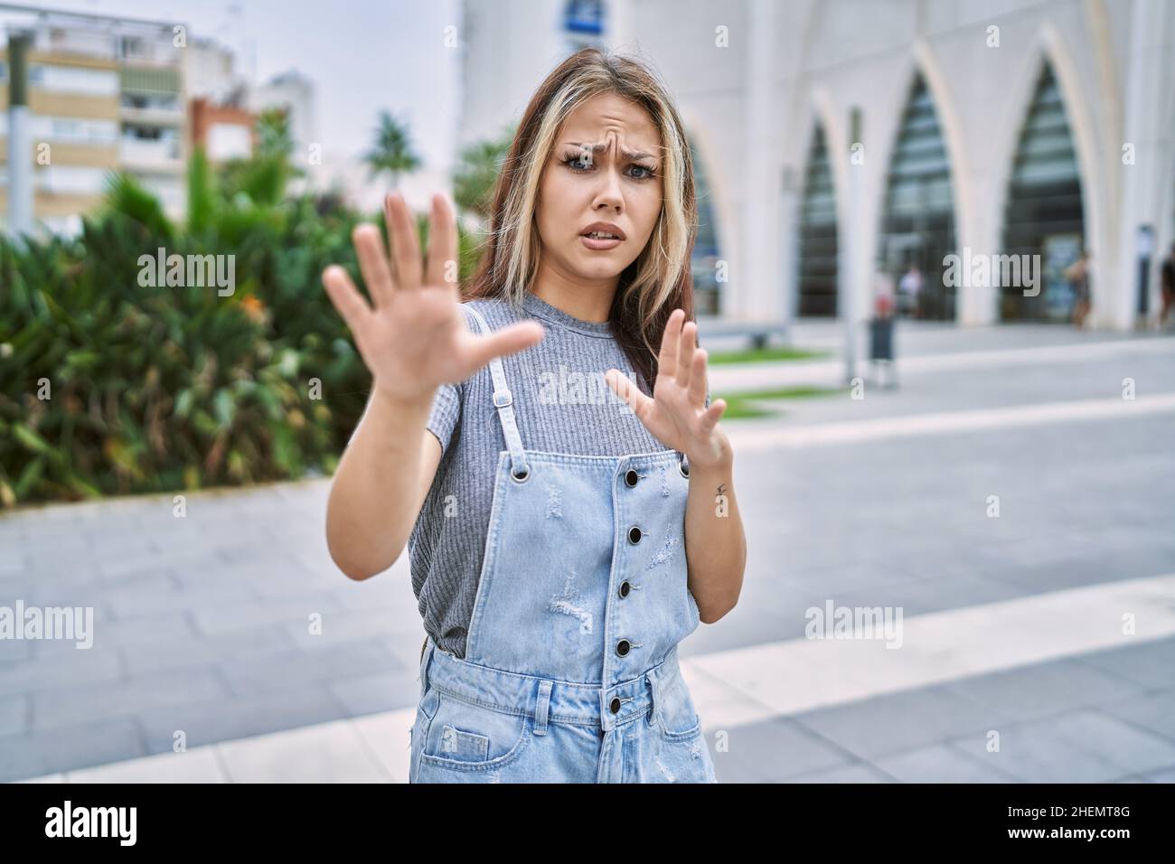 Young caucasian woman outdoors afraid and terrified with fear ...
