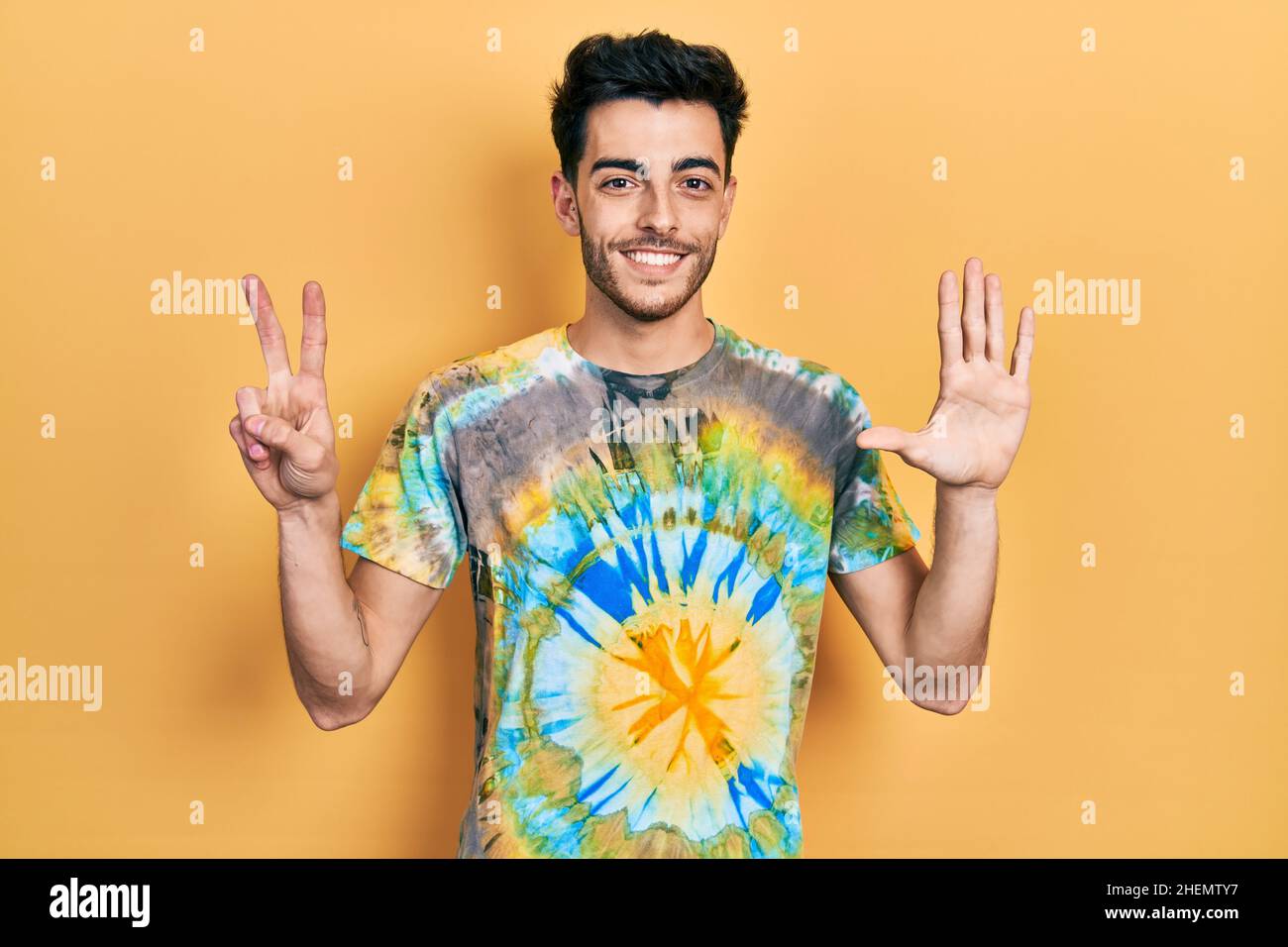 Young hispanic man wearing casual clothes showing and pointing up with ...