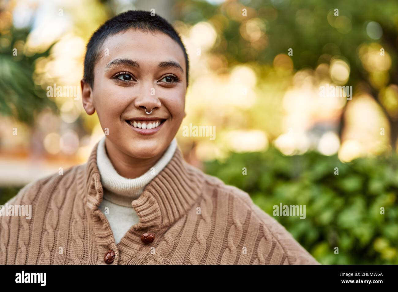Beautiful hispanic woman with short hair smiling happy outdoors Stock ...