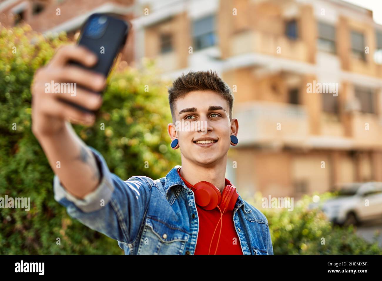 Young caucasian guy smiling taking a selfie picture at the city Stock ...