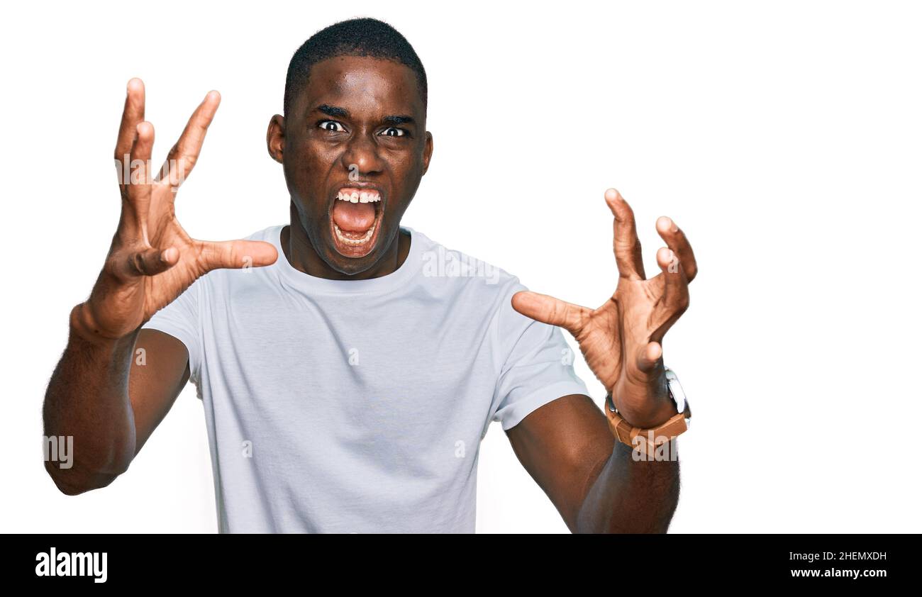 Young african american man wearing casual white t shirt shouting ...