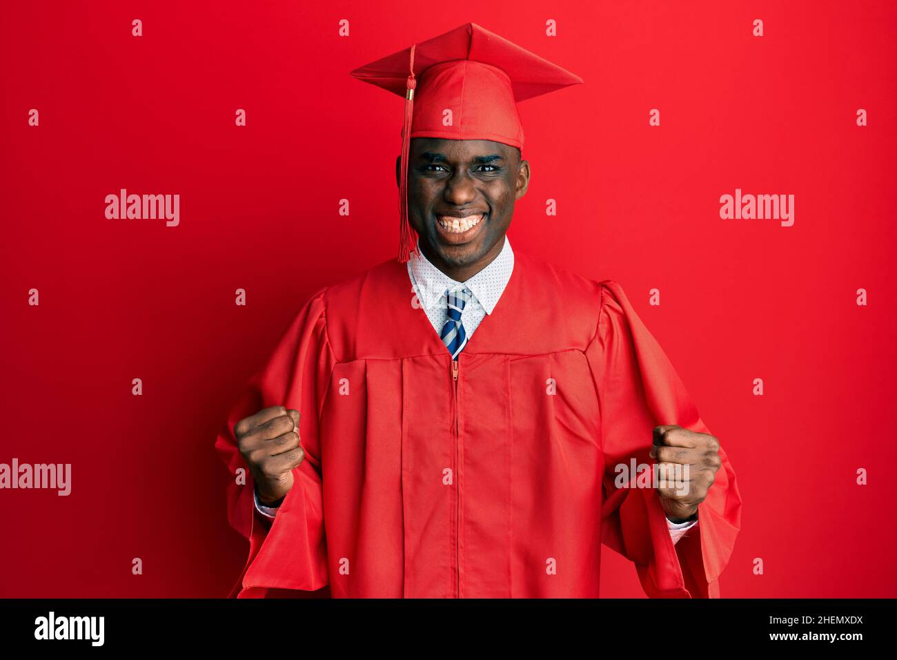 Young african american man wearing graduation cap and ceremony robe ...