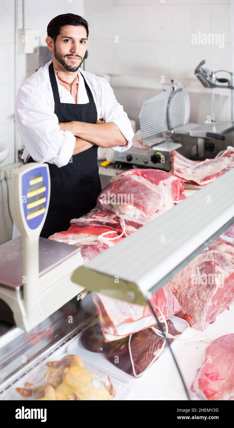 Portrait of man butcher who is posing with meat in the market Stock ...