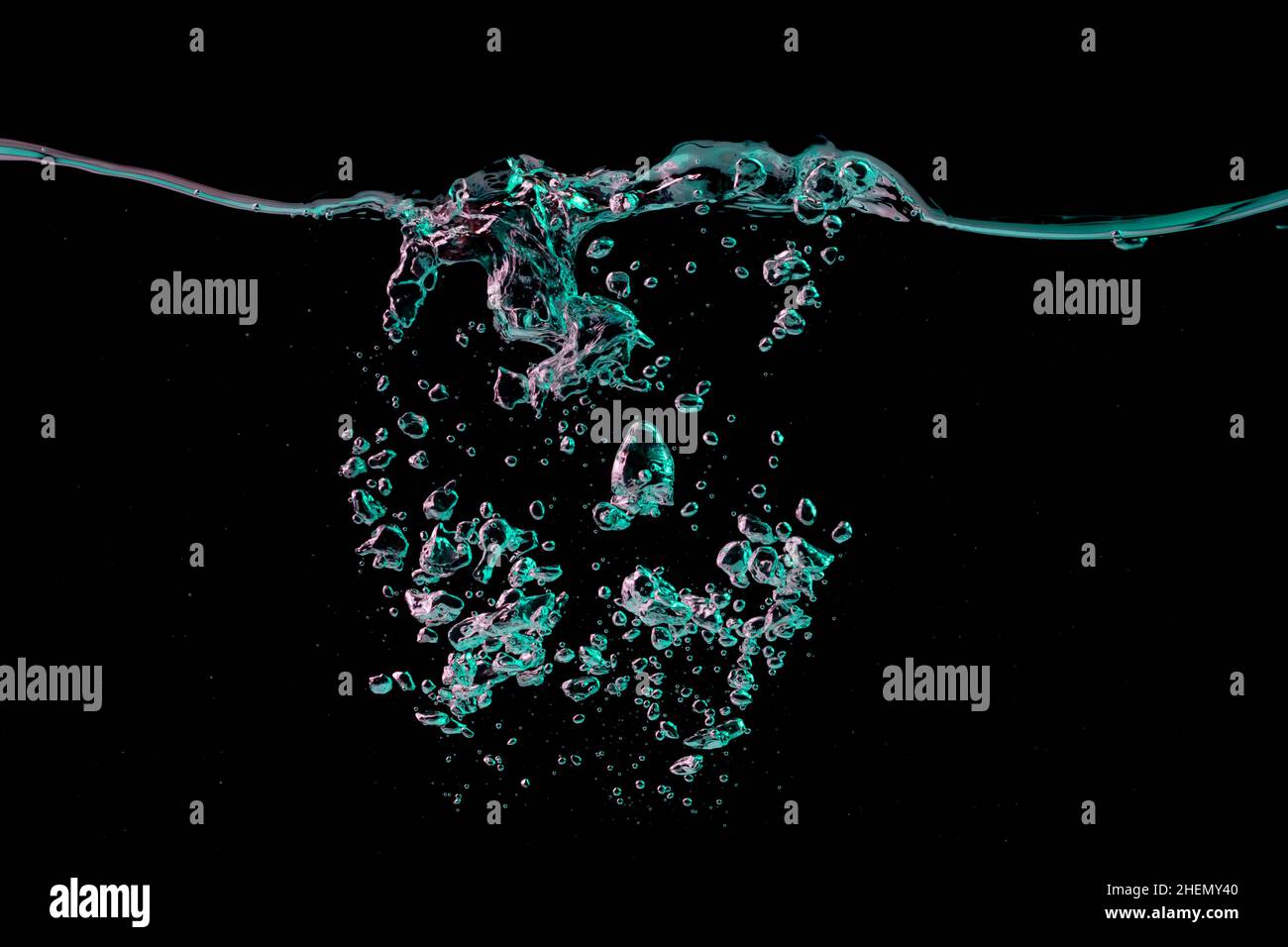Clear water surface with ripple and bubbles in green and blue light on ...