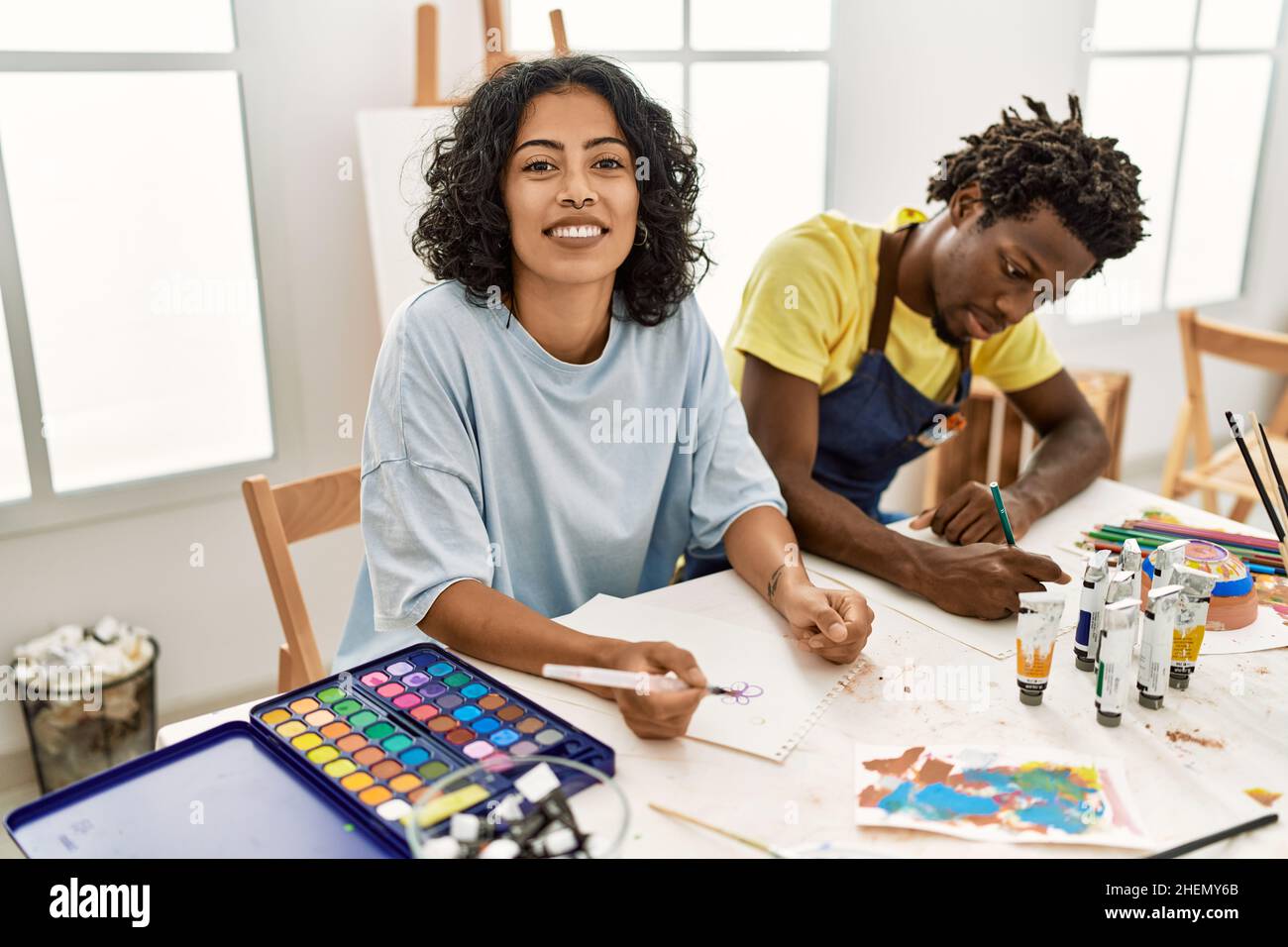 African american artist couple smiling happy painting sitting on the ...