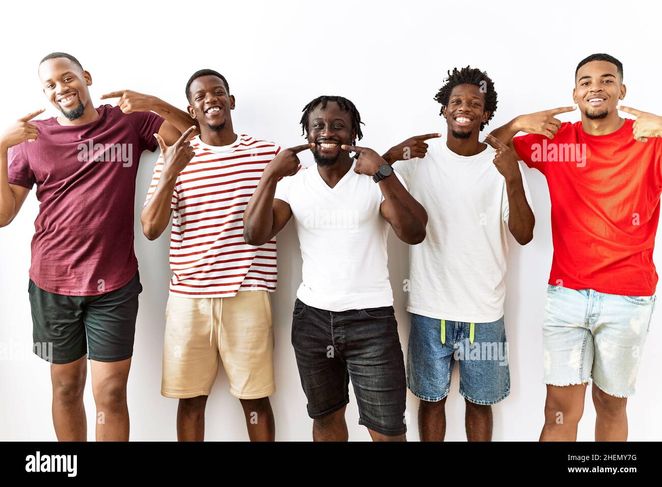 Young african group of friends standing together over isolated ...