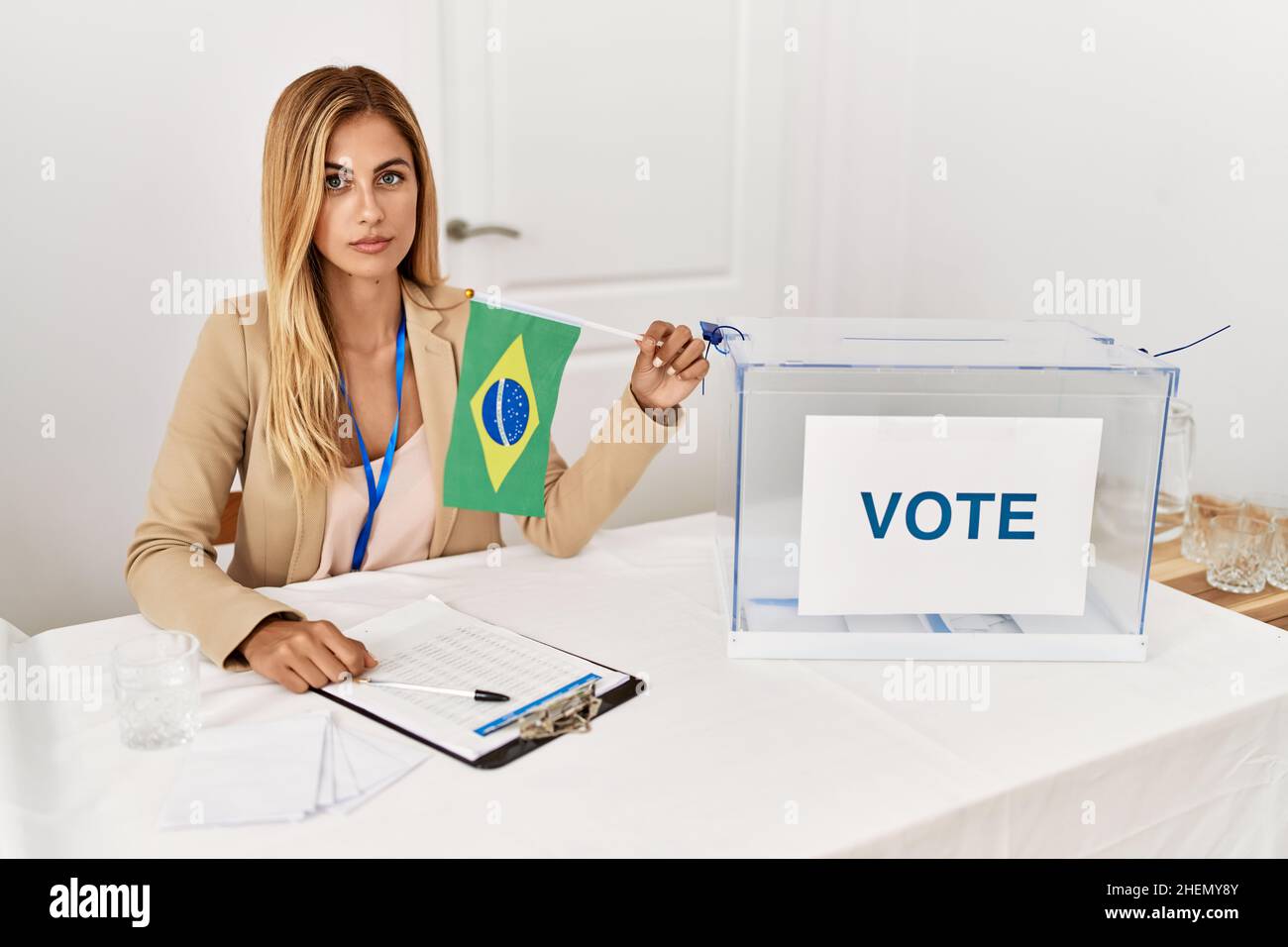 Blonde beautiful young woman at political campaign election holding ... Blonde beautiful young woman at political campaign election holding ...