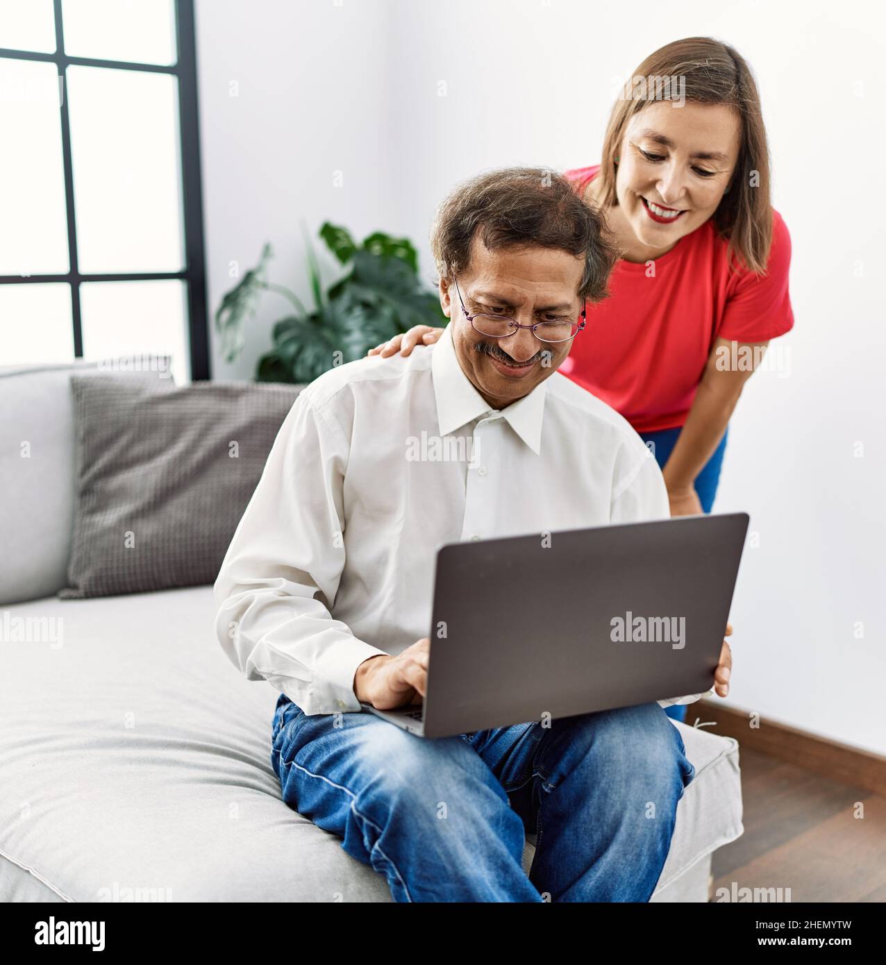 Middle age man and woman couple smiling confident using laptop at home ...