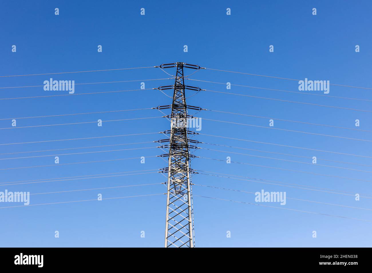 gray electric pylon under clear blue sky Stock Photo - Alamy