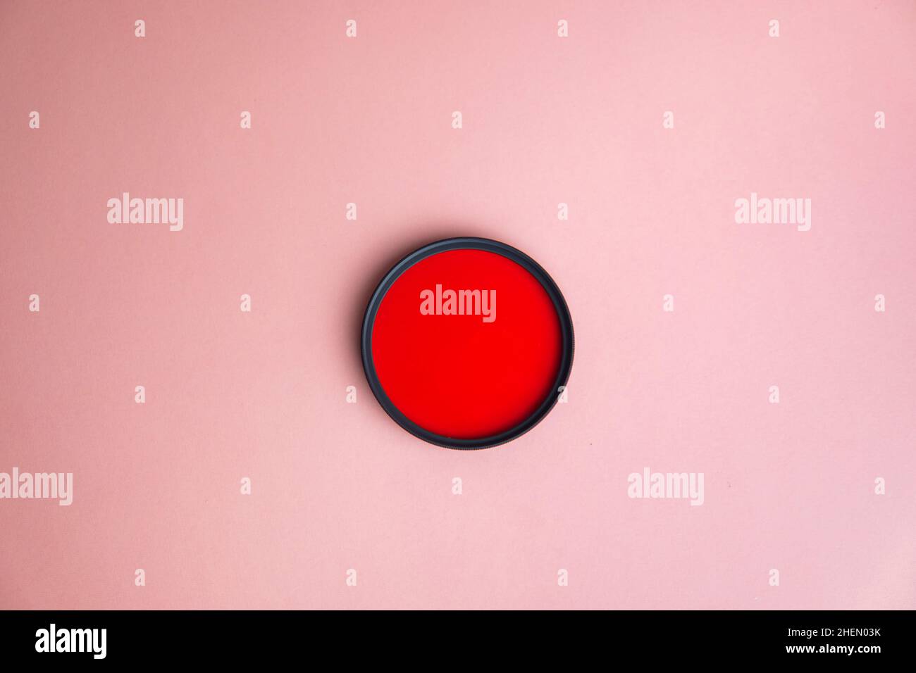 Red lens filter, on the pink background Stock Photo - Alamy