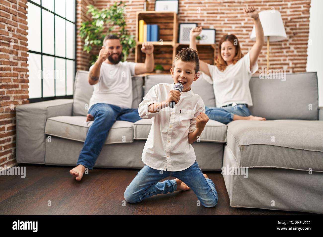 Family singing song using microphone at home Stock Photo - Alamy