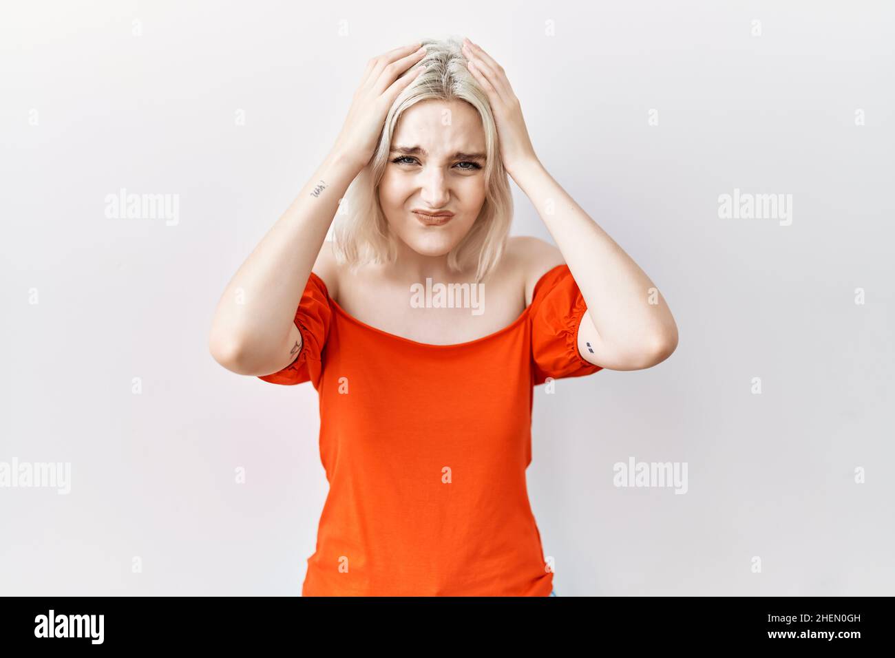 Young caucasian woman standing over isolated background suffering from ...