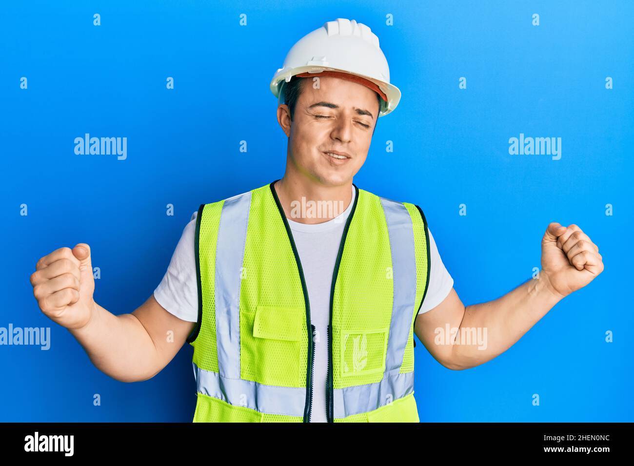 Handsome young man wearing safety helmet and reflective jacket very ...