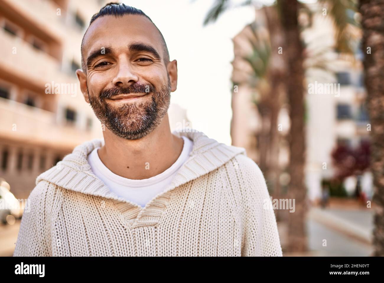 Handsome middle age man with beard standing happy and confident at the ...