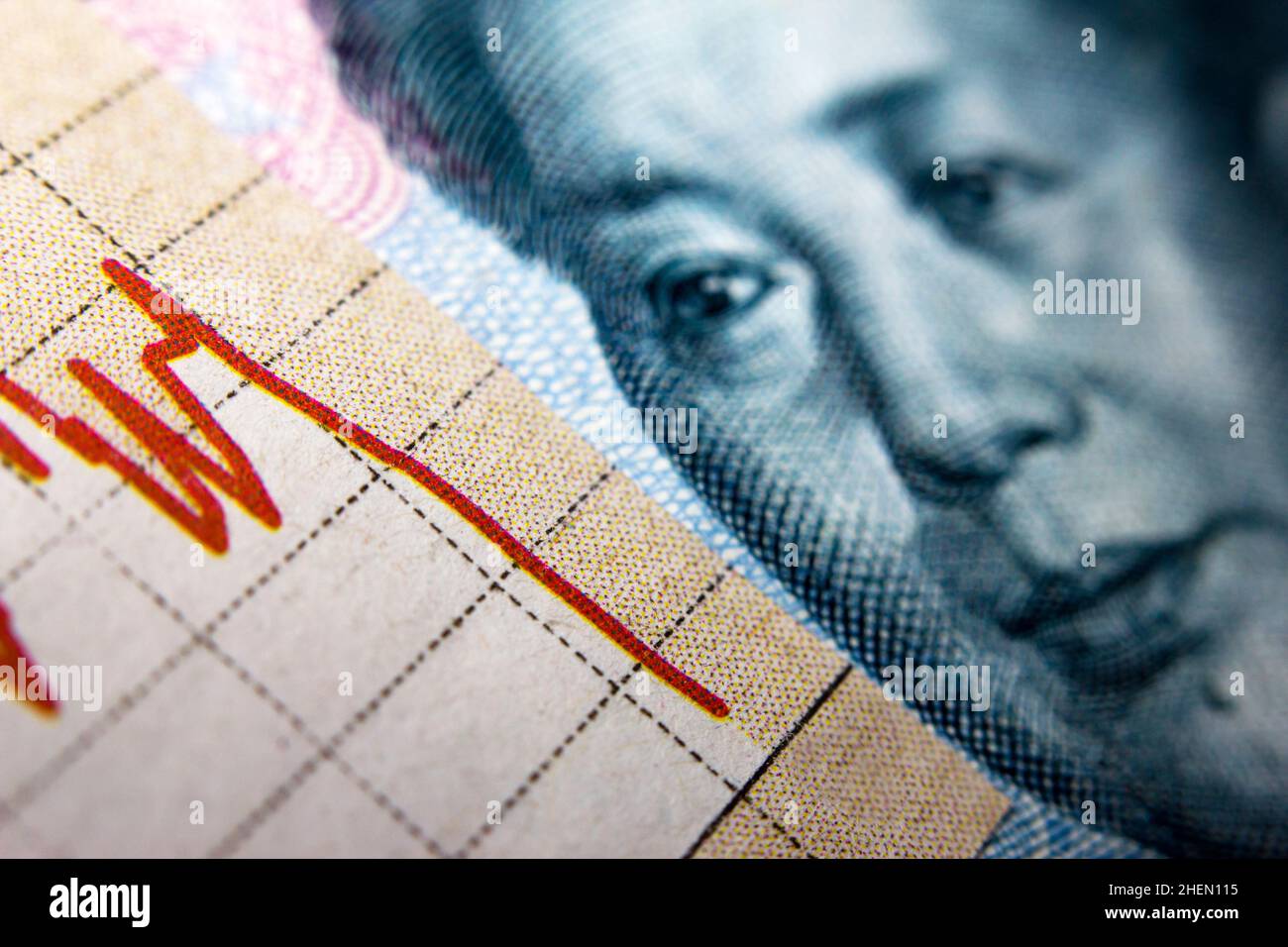 Stock Market Graph next to a Chinese Yuan banknote. Red trend line ...