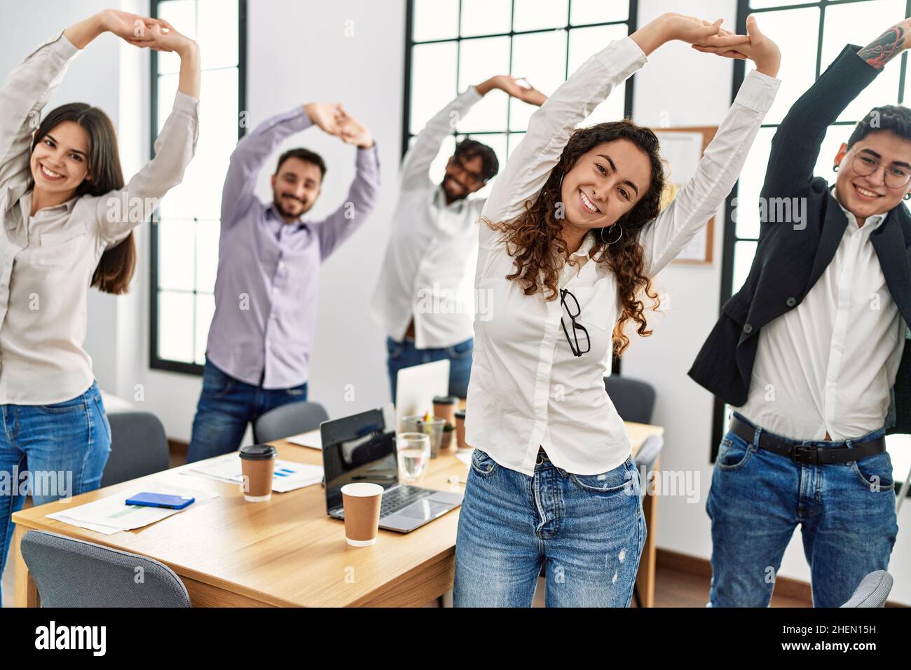 Group of business workers stretching arms in relax time standing at the ...