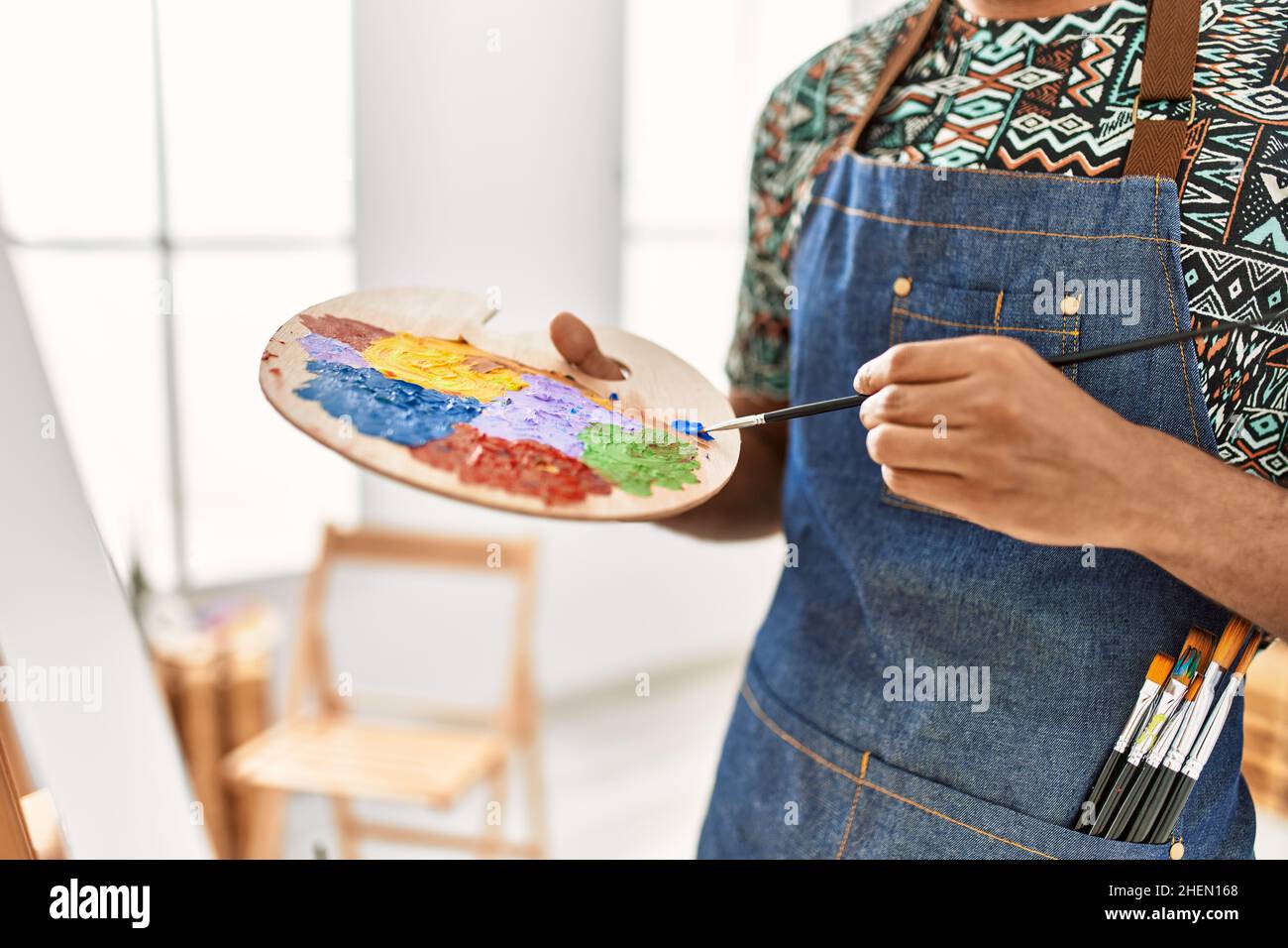 Hand of african american artist man painting at art studio Stock Photo ...