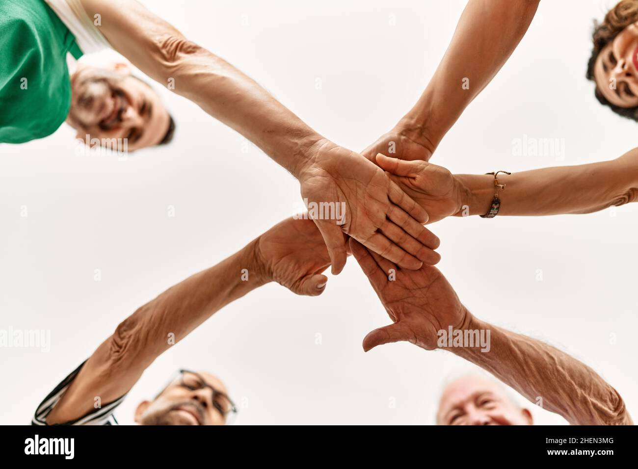 Group of middle age friends with hands together Stock Photo - Alamy