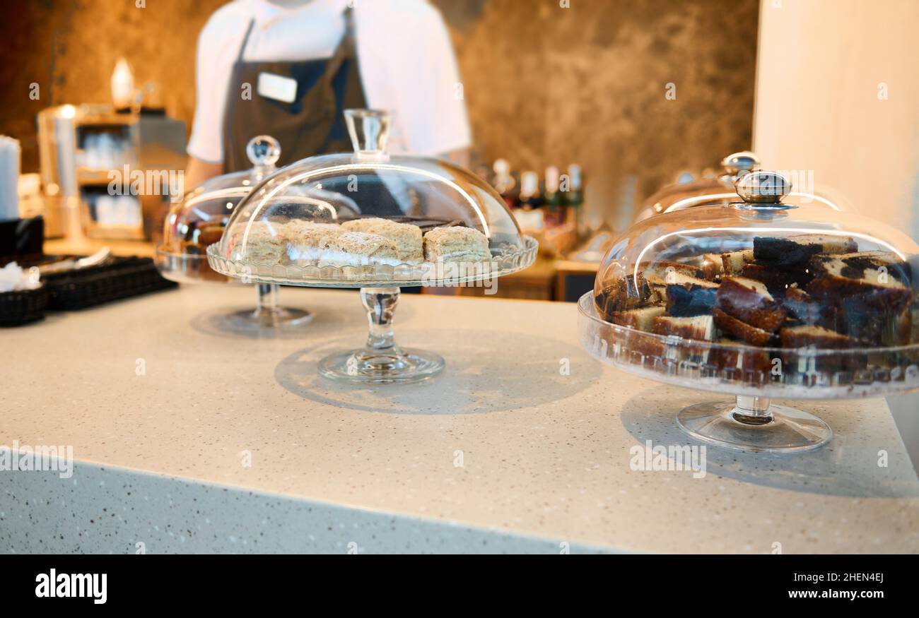 Image focused on cloche with pastries and chocolate cheese creamy ...