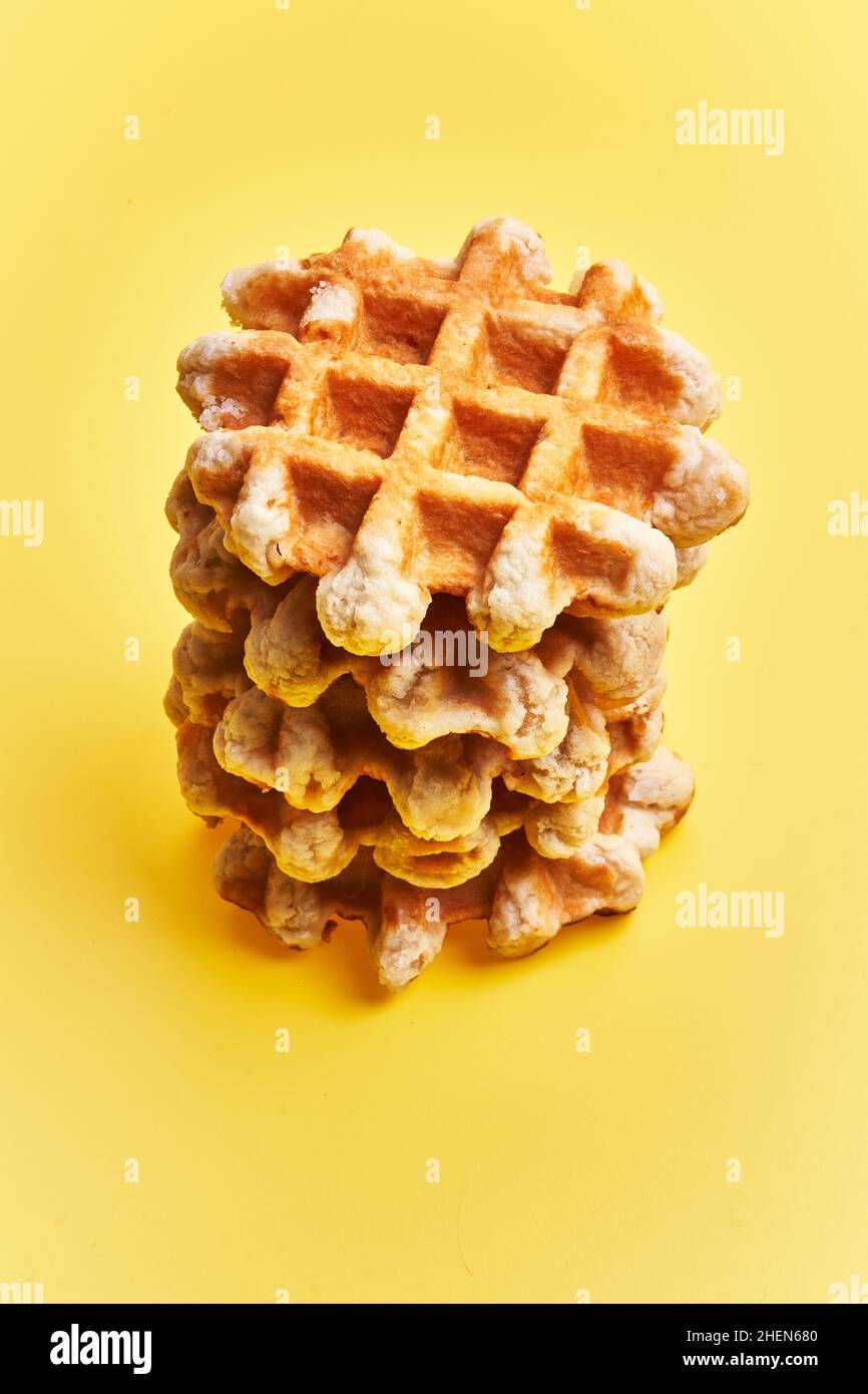 Bunch of delicious waffles over yellow background Stock Photo - Alamy