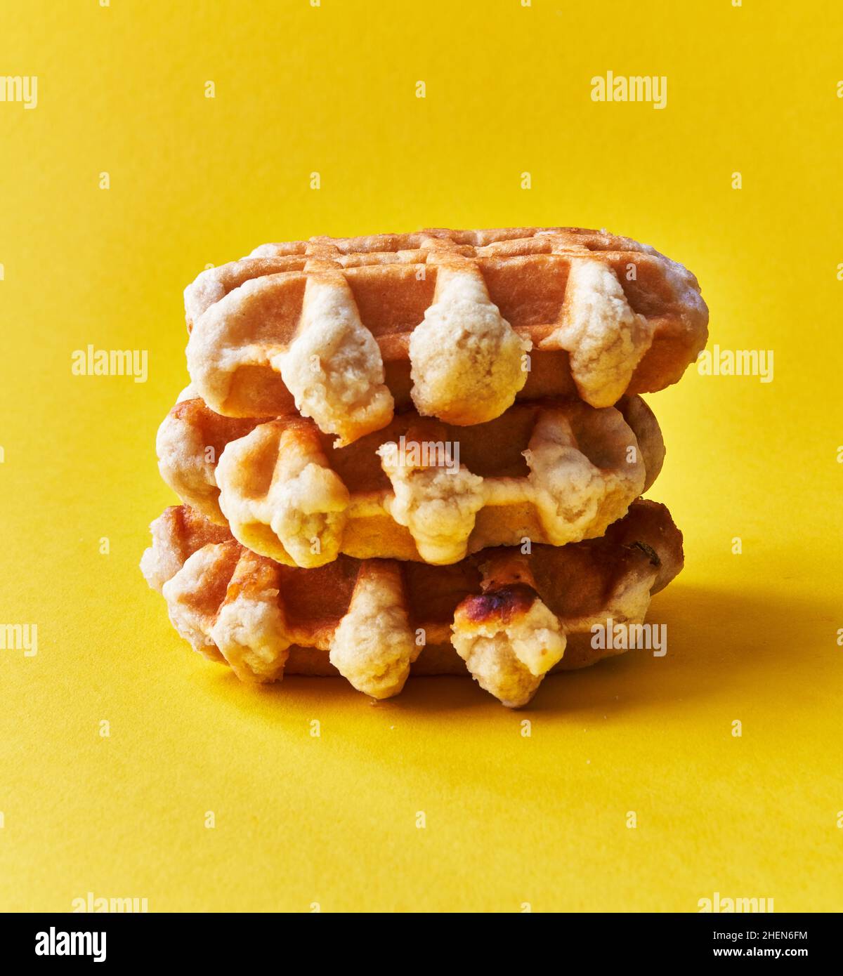Bunch of delicious waffles over yellow background Stock Photo - Alamy