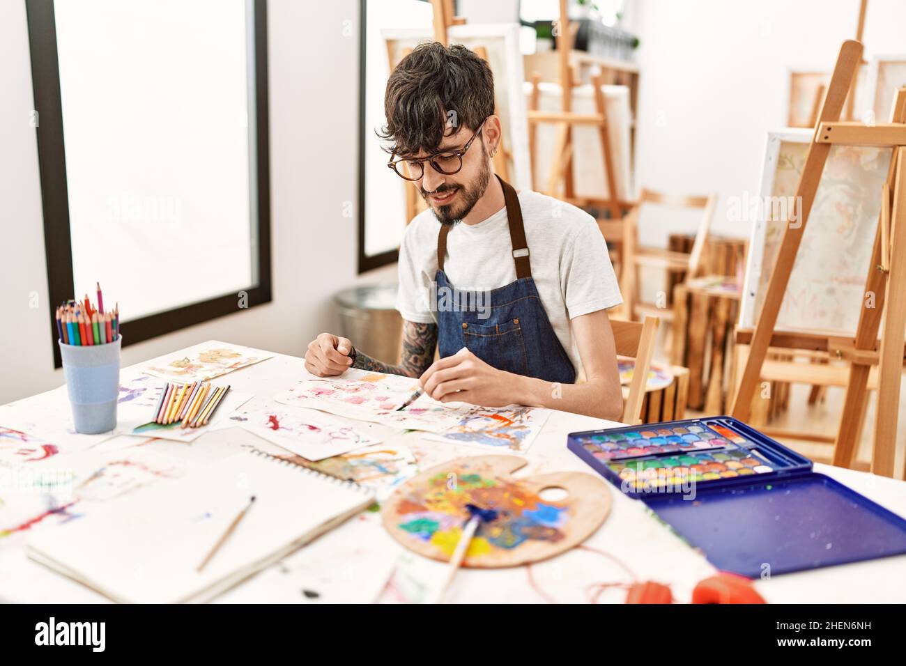 Young hispanic artist man smiling happy drawing at art studio Stock ...