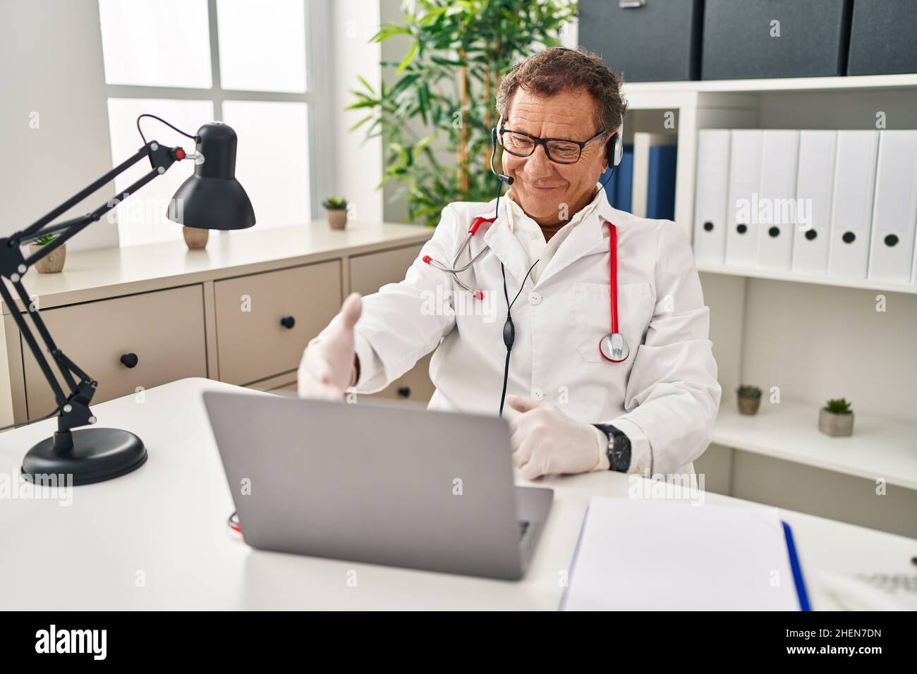 Senior doctor man working on online appointment smiling friendly ...