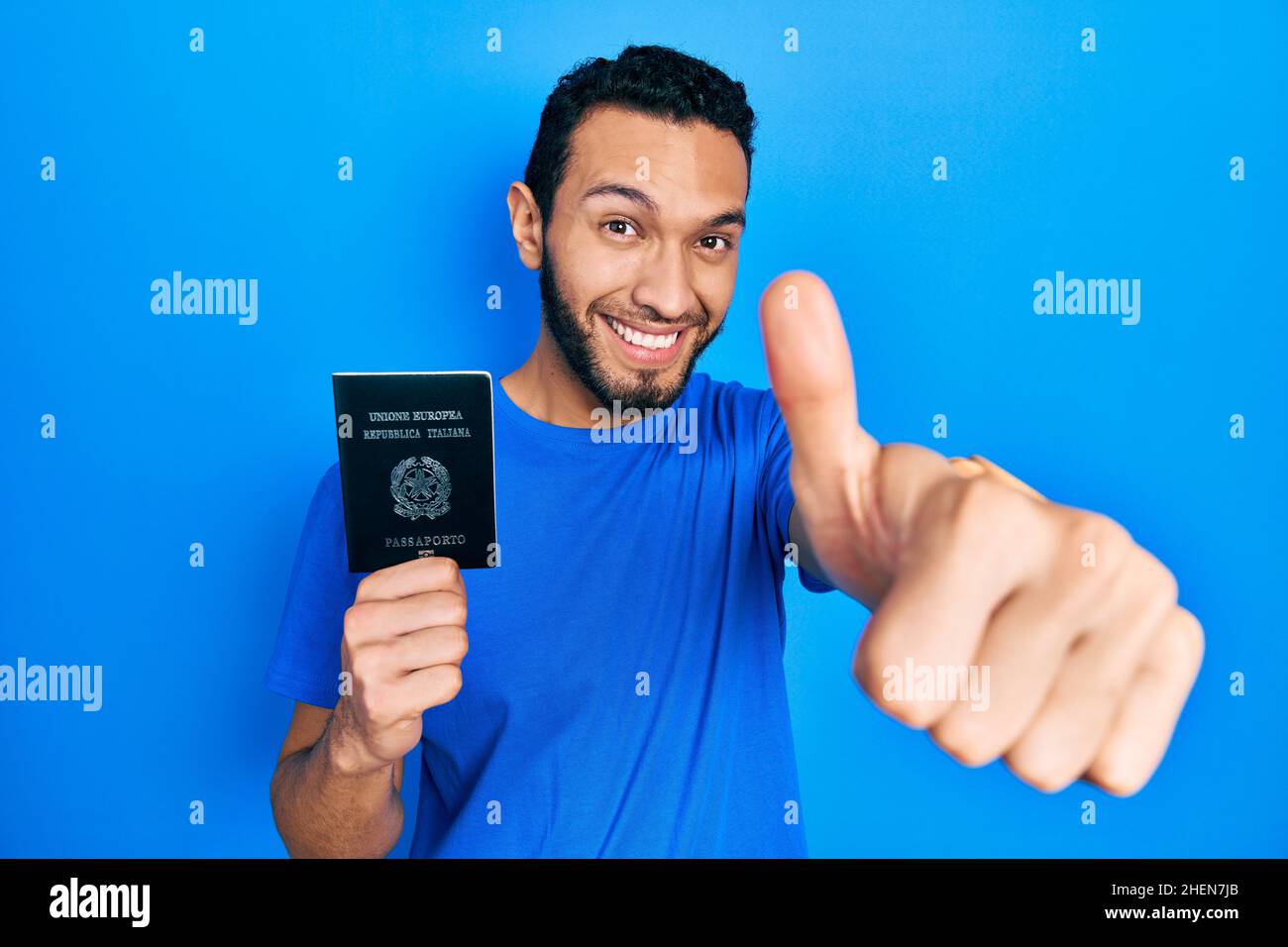 Hispanic man with beard holding italy passport approving doing positive ...